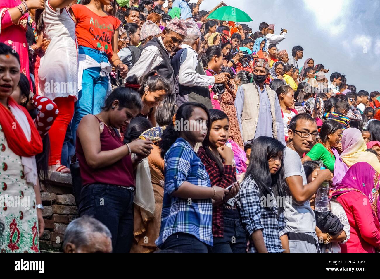 Crowds of Nepalese people gathered on the stairs of Maju Dega temple to ...