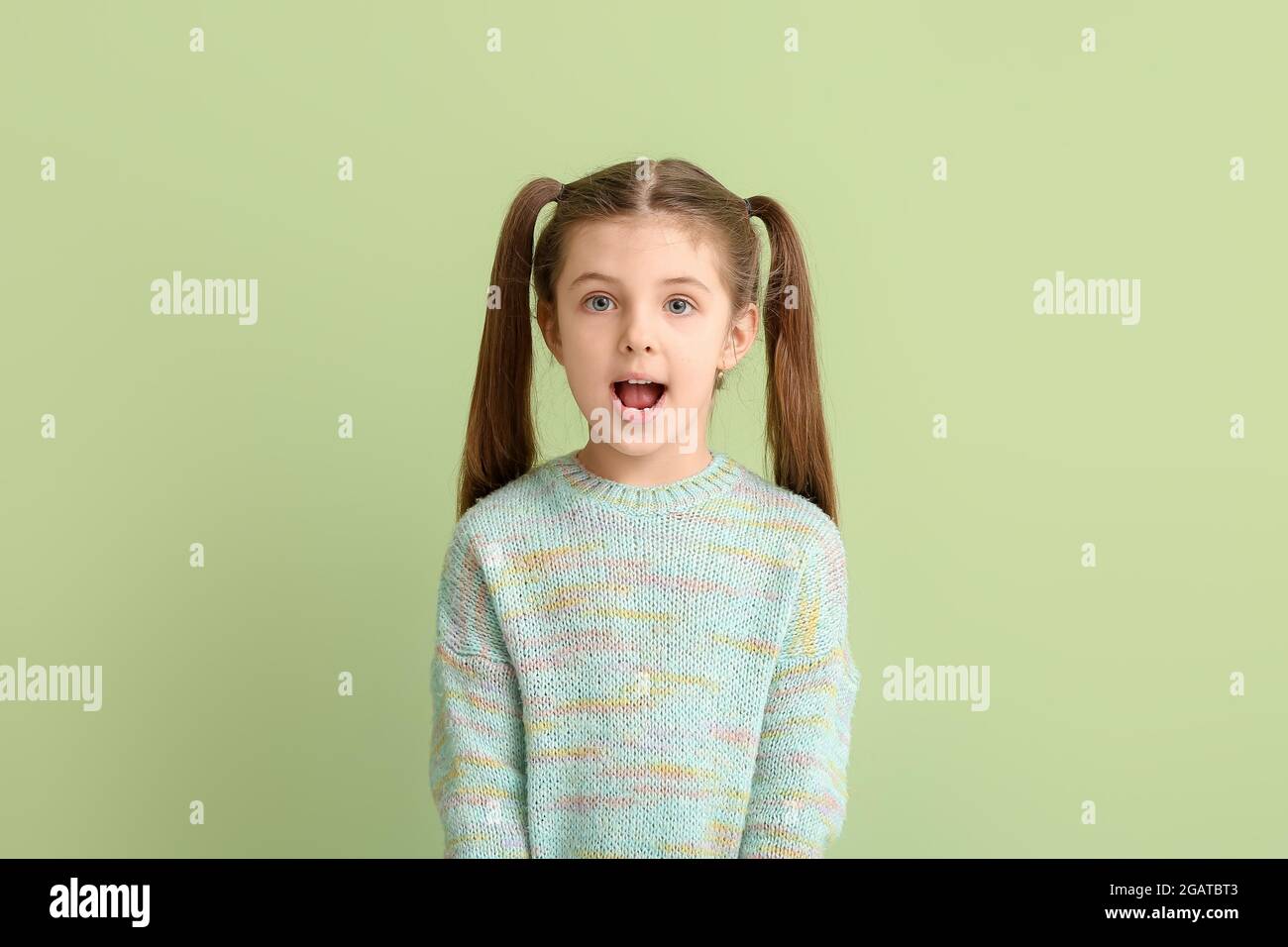 Little girl training pronounce letters on color background Stock Photo ...