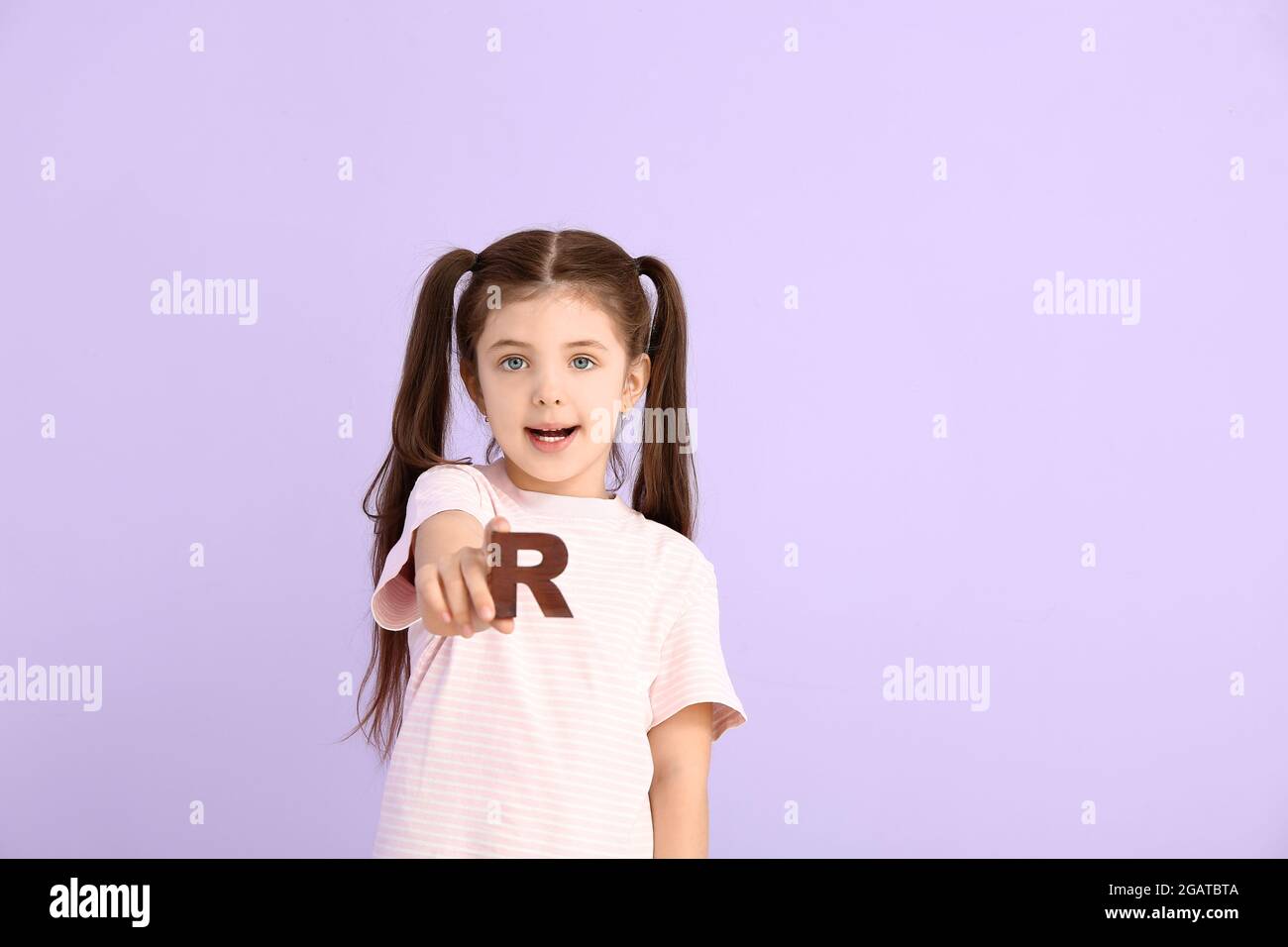 Little girl with letter R on color background Stock Photo - Alamy