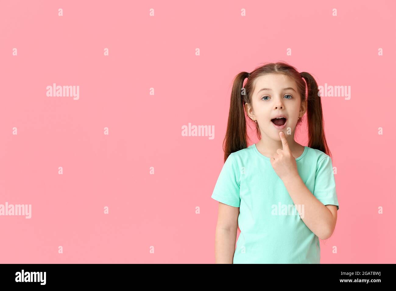 Little girl training pronounce letters on color background Stock Photo ...