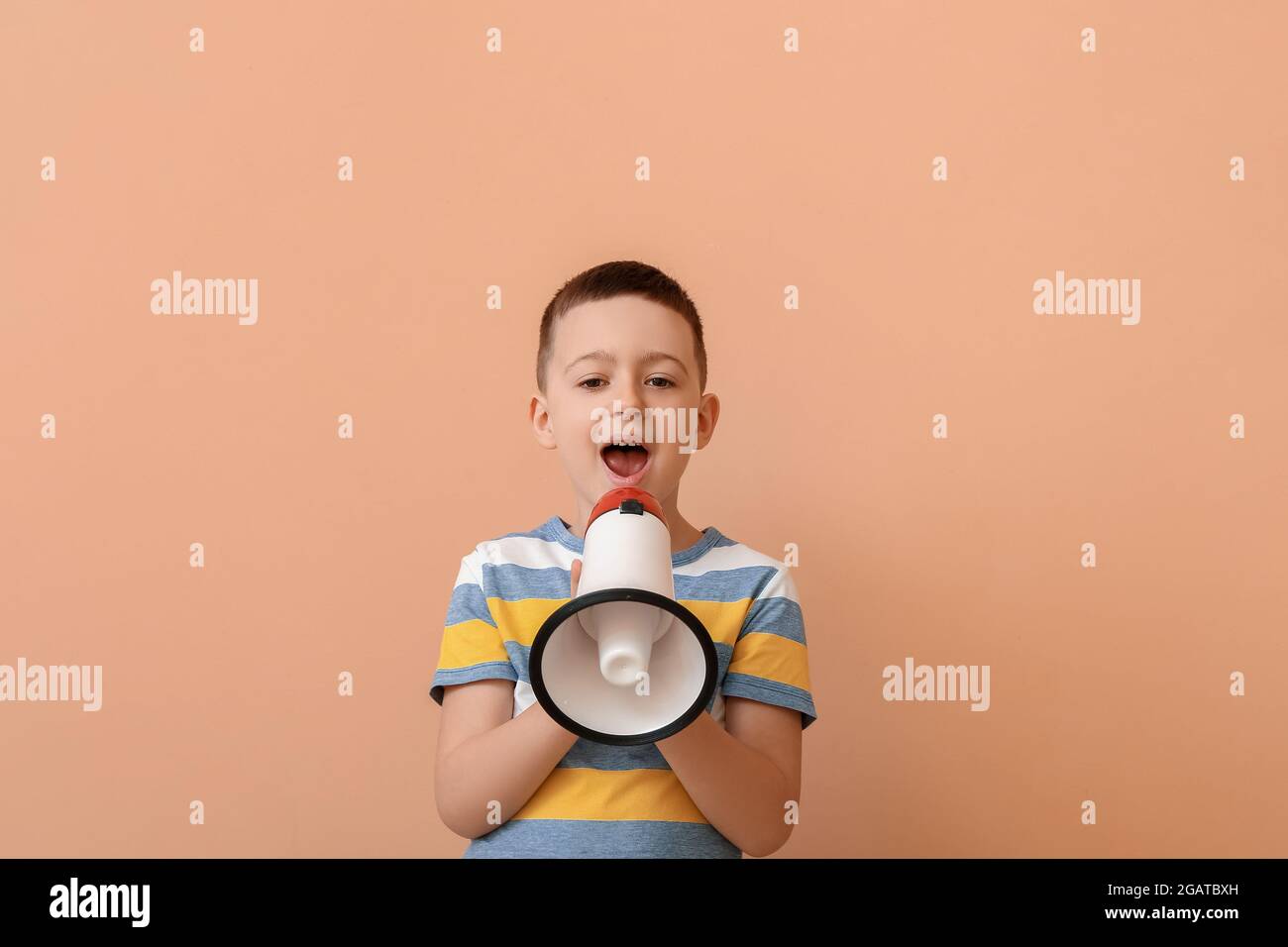 Little boy with megaphone training pronounce letters on color ...