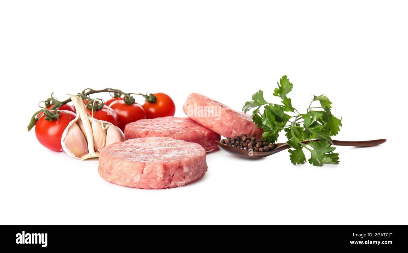 Raw cutlets made of fresh forcemeat and ingredients on white background ...