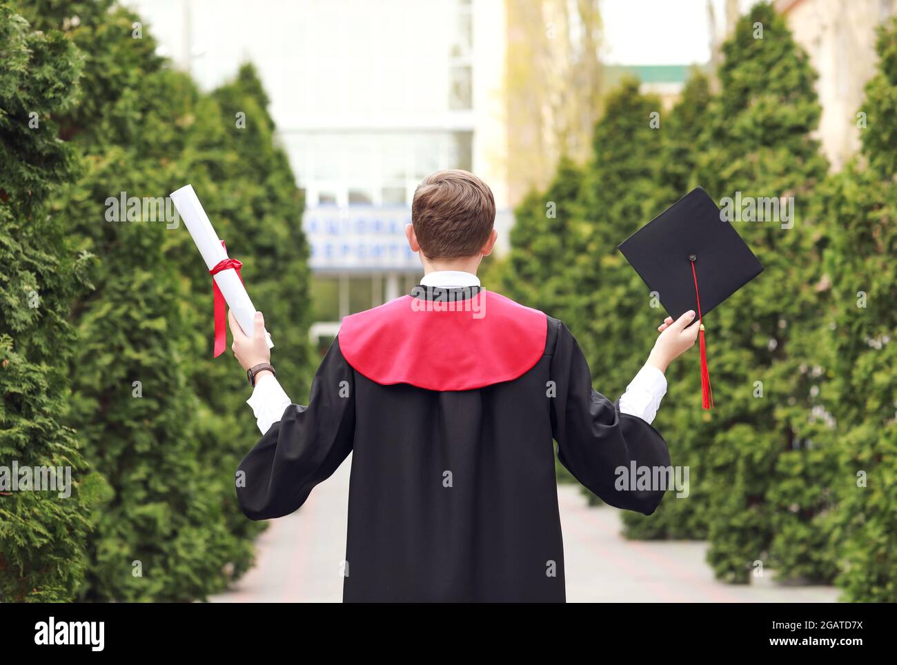 Male graduating student outdoors, back view Stock Photo - Alamy