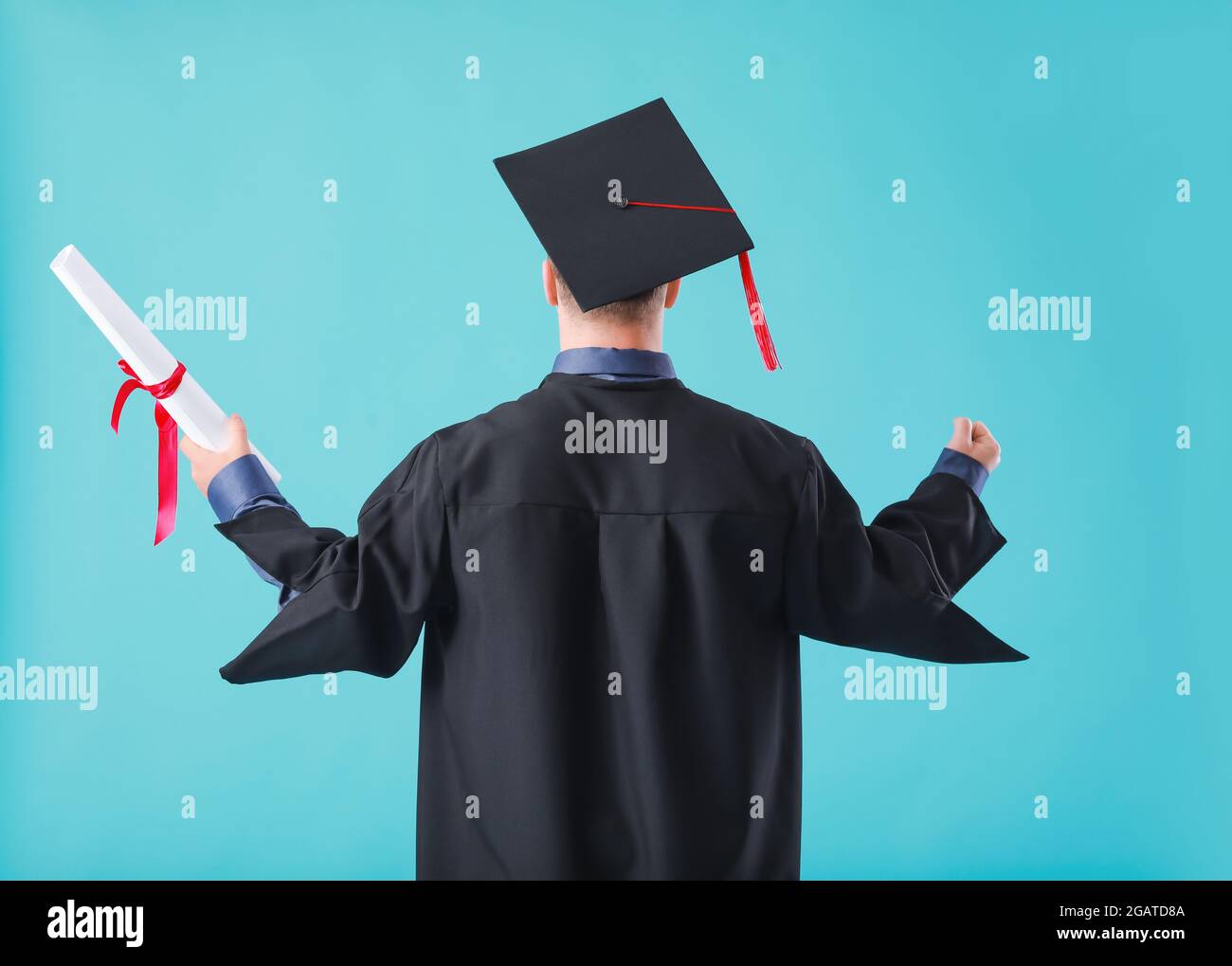 Happy graduating student on color background Stock Photo - Alamy