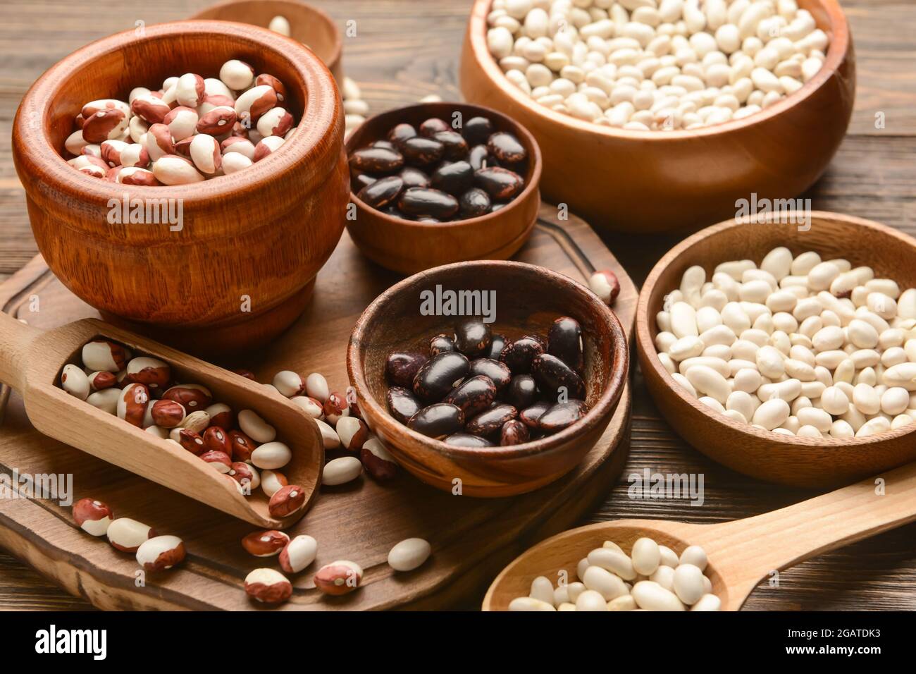 Different types of beans on wooden background Stock Photo - Alamy