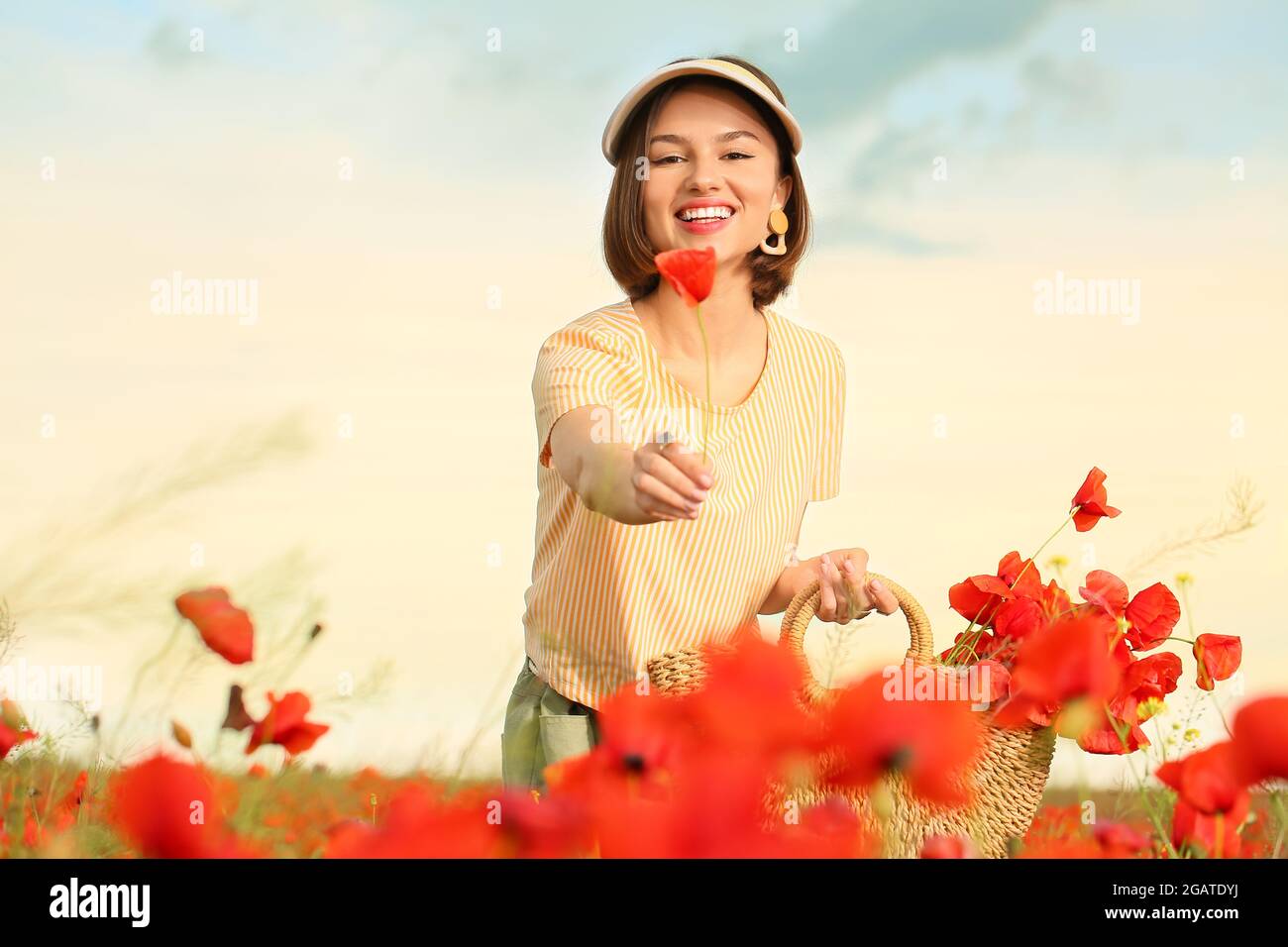 Beautiful young woman in poppy field Stock Photo - Alamy