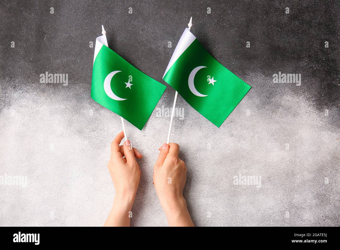 Female hands with Pakistan flags on black and white background Stock ...