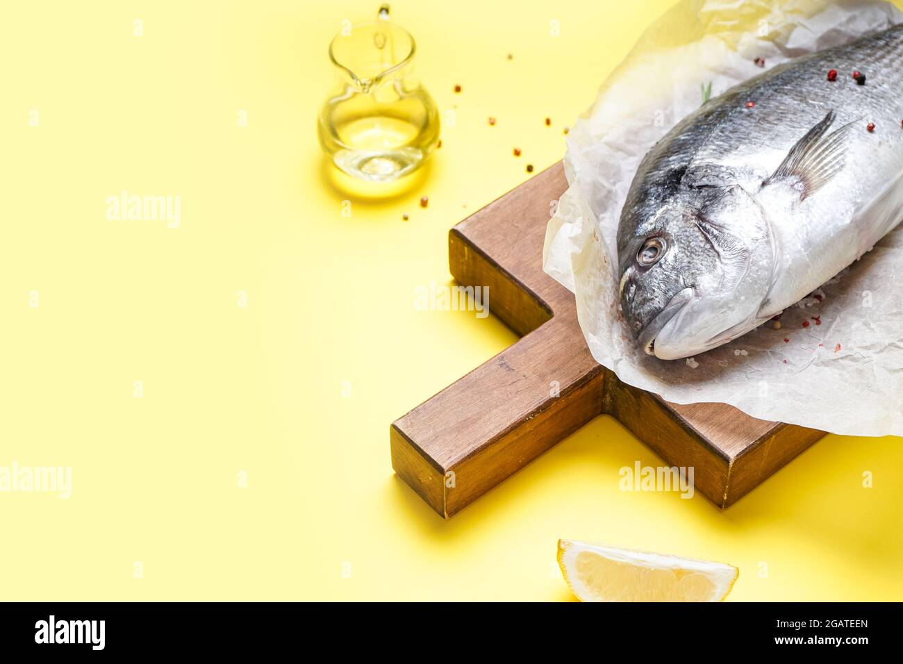 Board with raw dorado fish on color background Stock Photo - Alamy