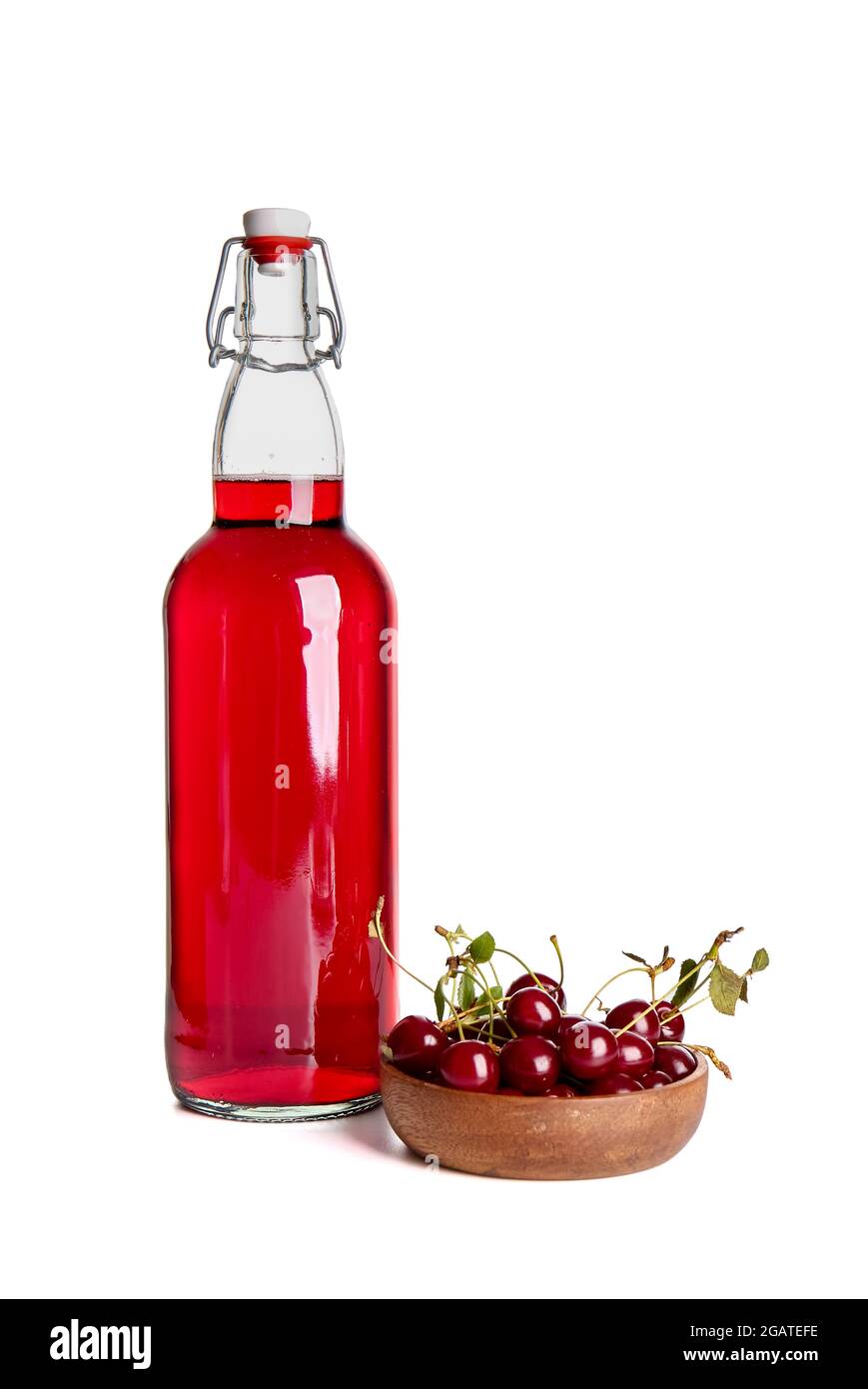 Bottle of sweet cherry wine on white background Stock Photo - Alamy