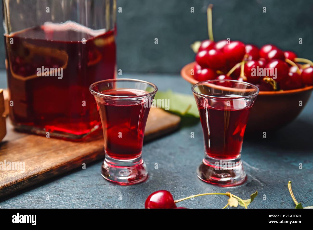 Glasses of sweet cherry wine on color background Stock Photo - Alamy