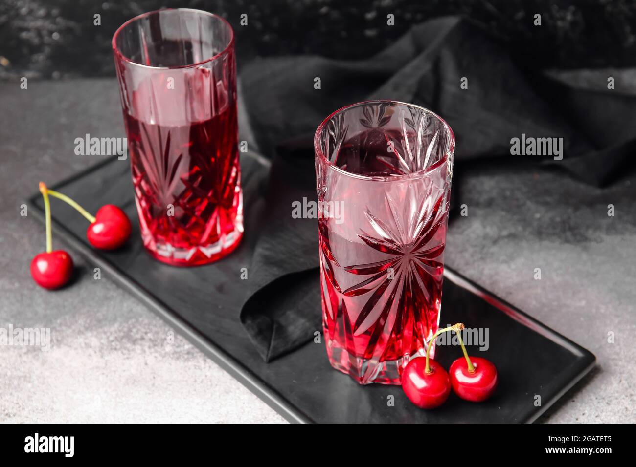 Glasses of sweet cherry wine on black and white background Stock Photo ...