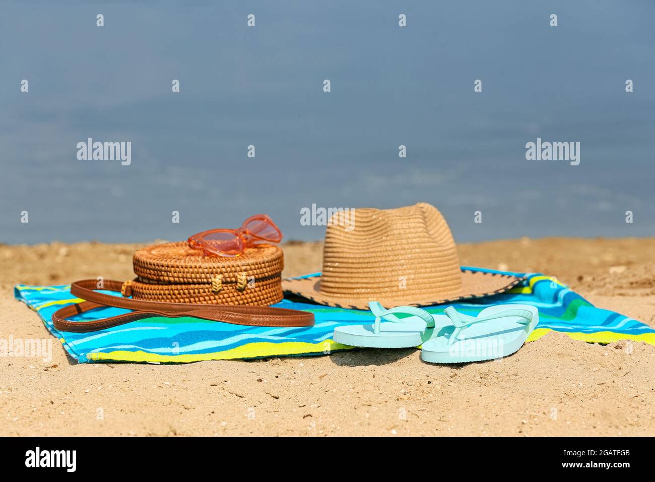Stylish flip-flops and accessories on sea beach Stock Photo - Alamy