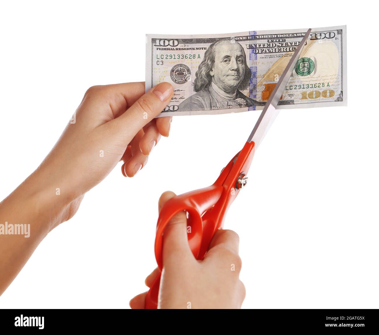 Hands with scissors cutting dollar banknote, isolated on white Stock ...
