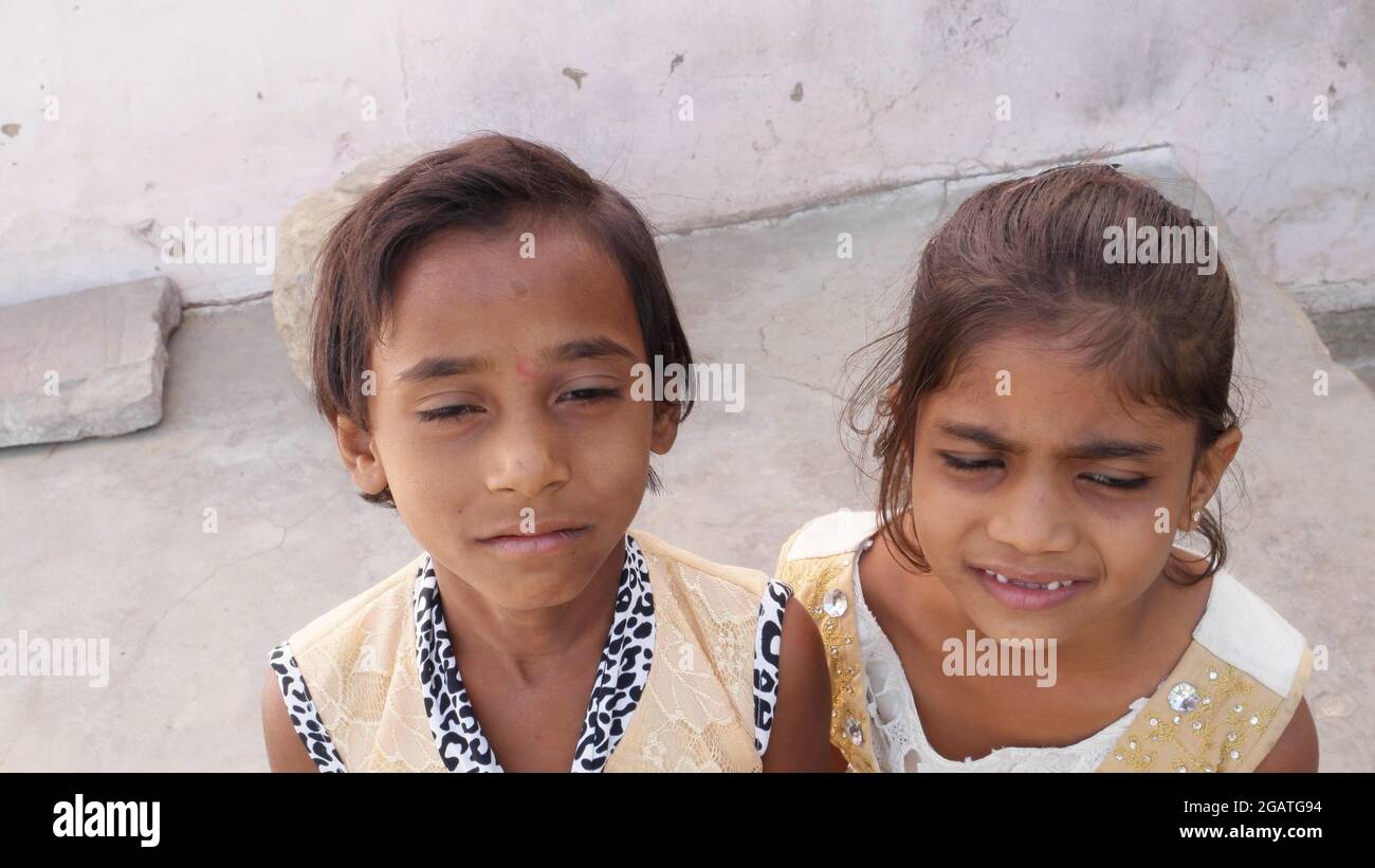 Indian poor children with closed eyes smiling Stock Photo - Alamy