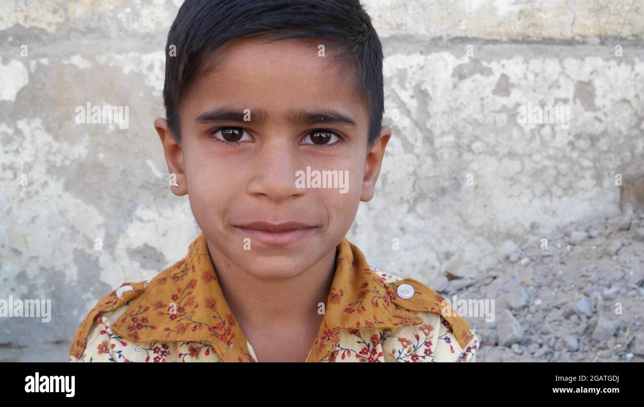 An Indian kid looking at the camera and smiling Stock Photo - Alamy