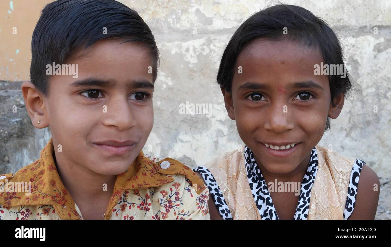 Indian poor children looking at the camera and smiling Stock Photo - Alamy