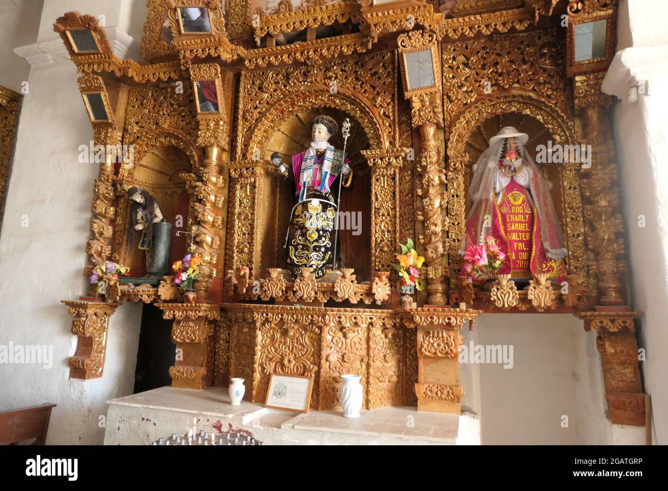 Inside the church in Colca Canyon in Peru front dolls priest God Jesus ...