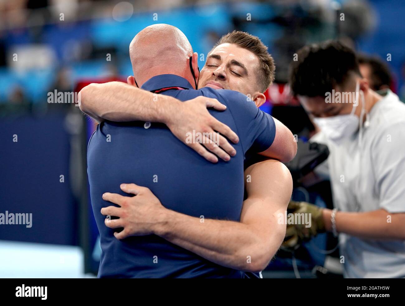 Great Britain's Max Whitlock hugs his coach Scott Hann during the Men's ...