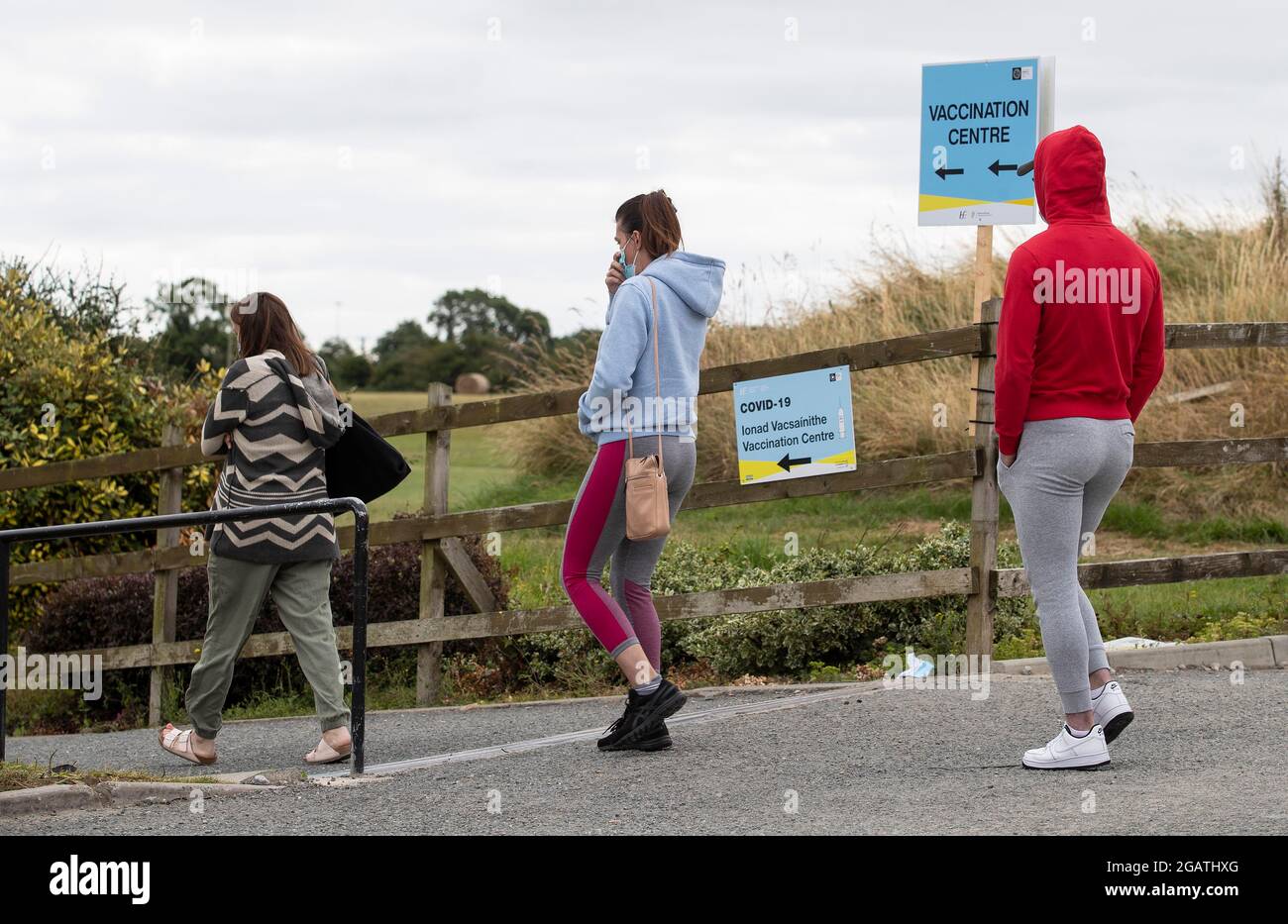People queue outside a walk-in vaccination centre at the National Show ...