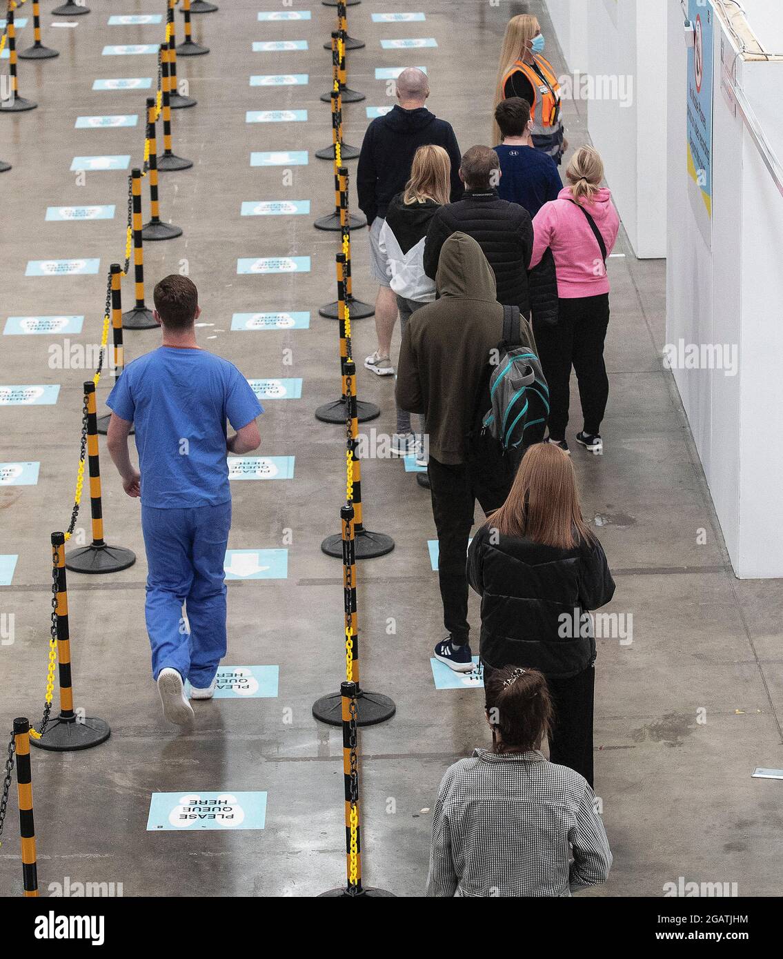 People queue inside a walk-in vaccination centre at the National Show ...