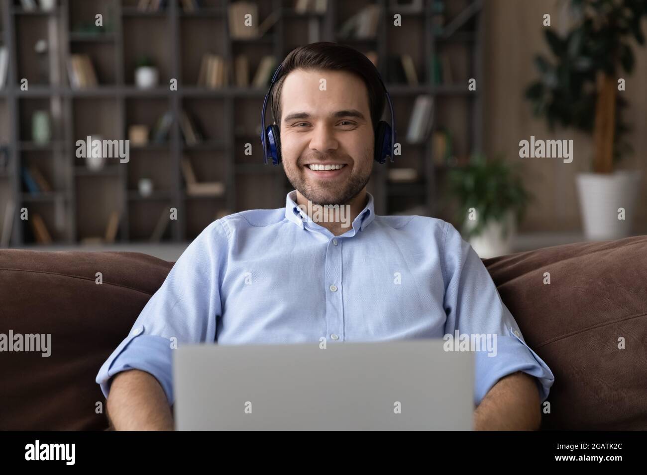 Young guy in headset look at camera above pc screen Stock Photo - Alamy