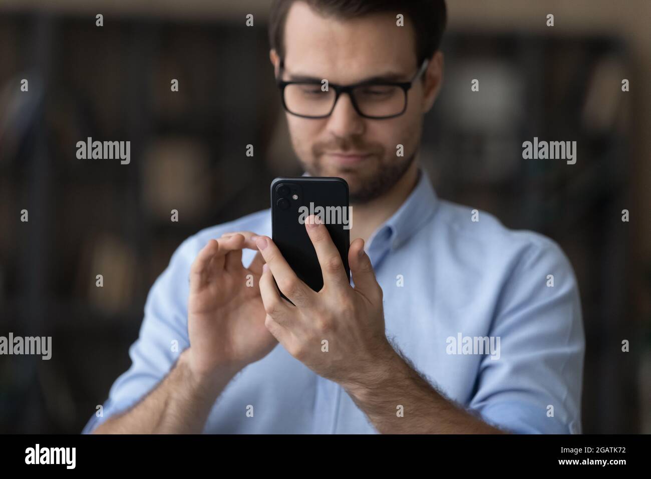 Confident businessman hold mobile phone look on screen make call Stock ...