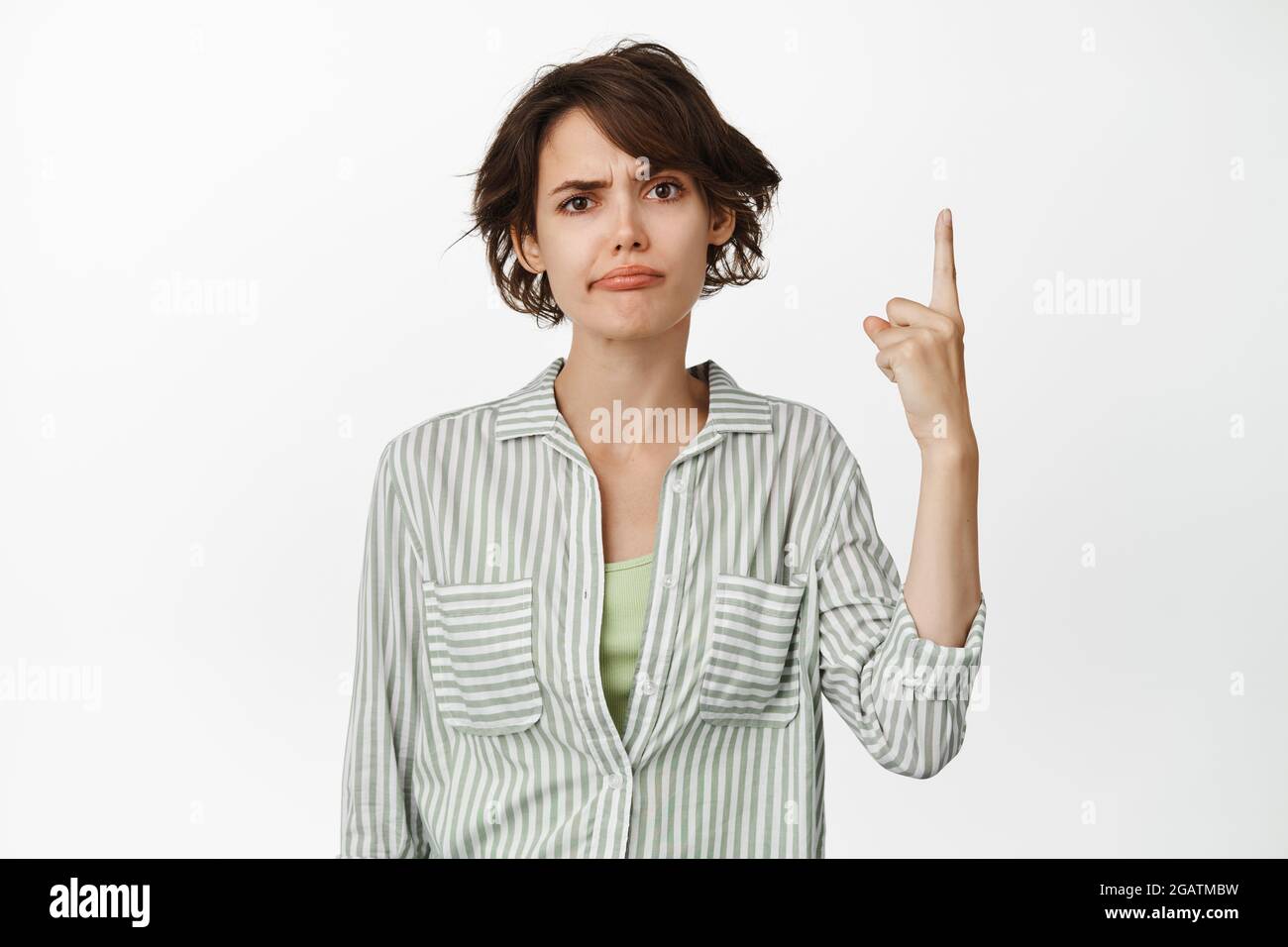 Image of skeptical young woman smirking, frowning upset, pointing ...