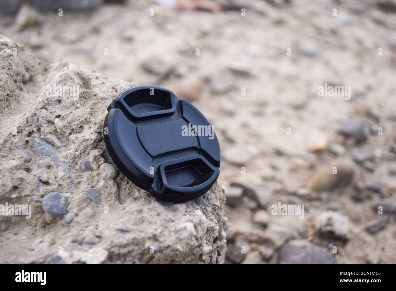 DSLR camera protector cap, lens cover on rock stone background photo ...
