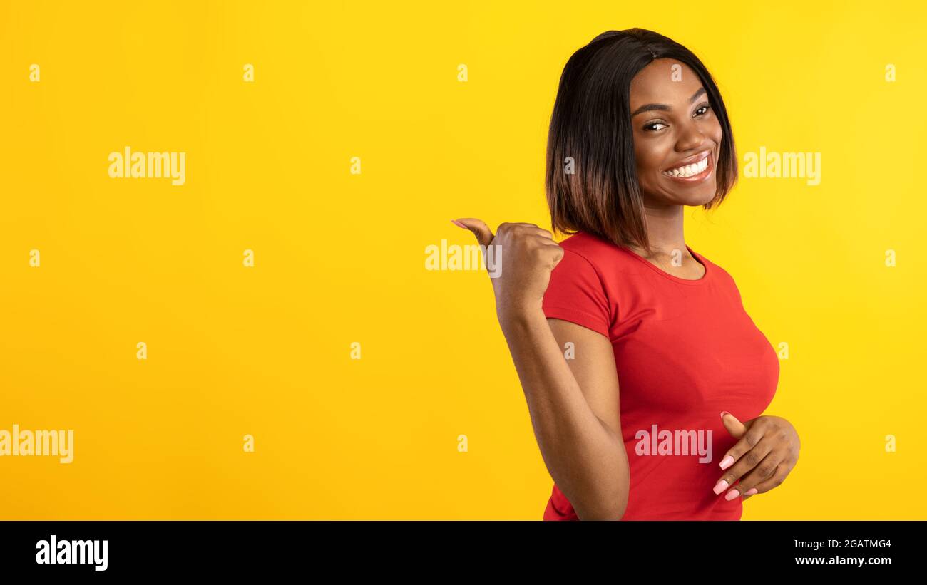 Look At This Offer. Cheerful Black Woman Pointing Thumb Aside At Free ...