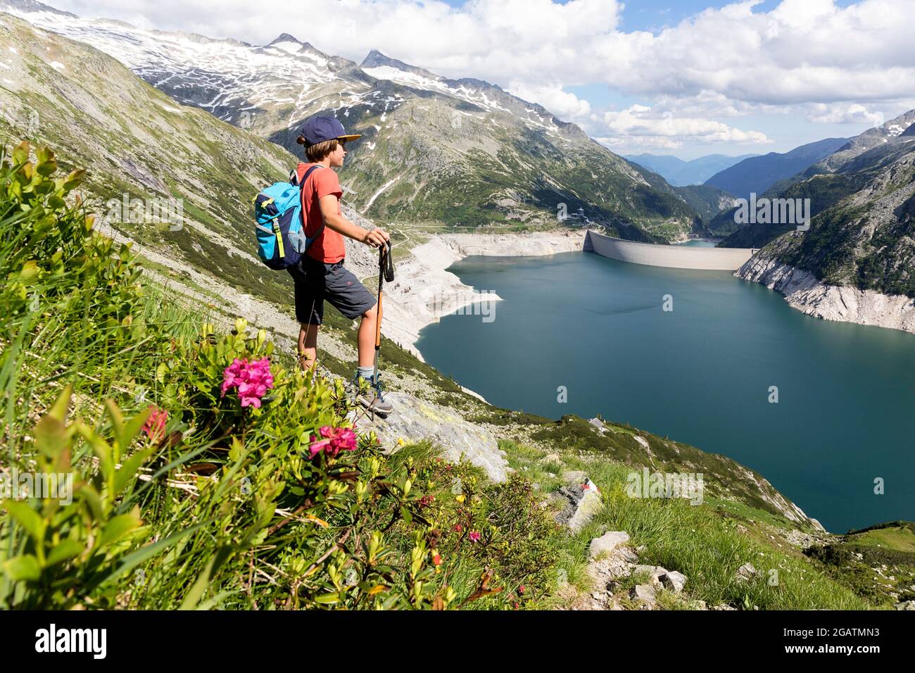 Boy hiking to Arlscharte pass above lake Koelnbrein in the Malta-Valley ...