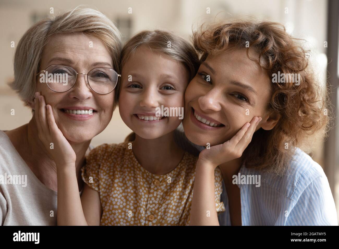 Head shot portrait happy three generations of women posing together ...