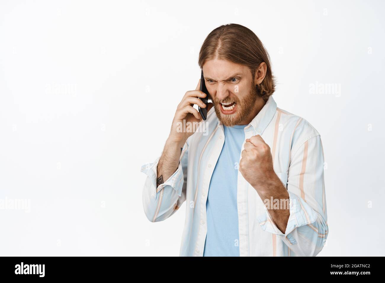 Image of angry blond bearded man cursing on phone call, screaming ...