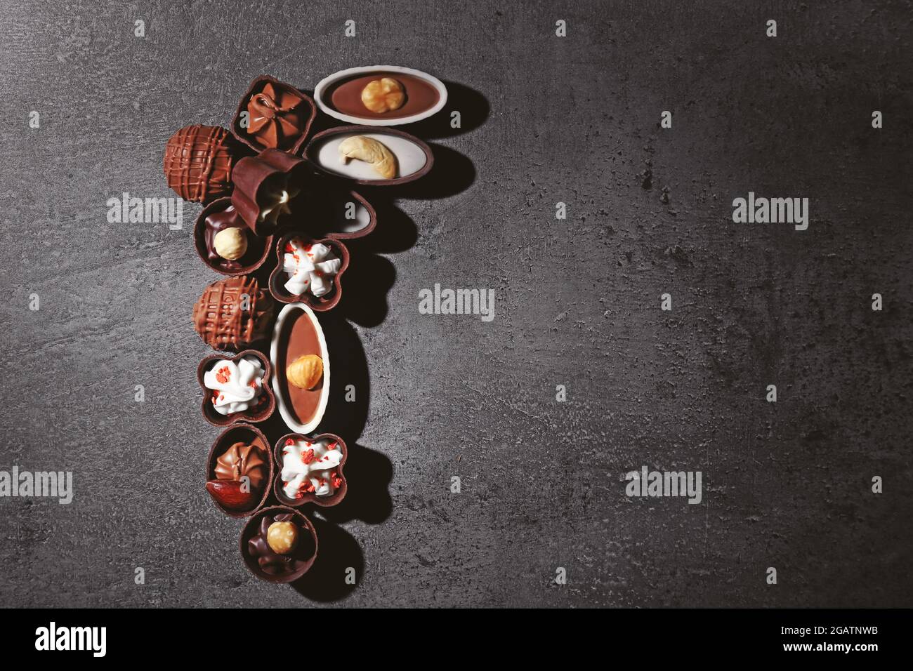 Chocolate sweets on dark grey background Stock Photo - Alamy