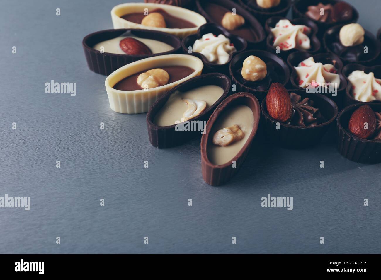 Chocolate sweets on dark grey background Stock Photo - Alamy