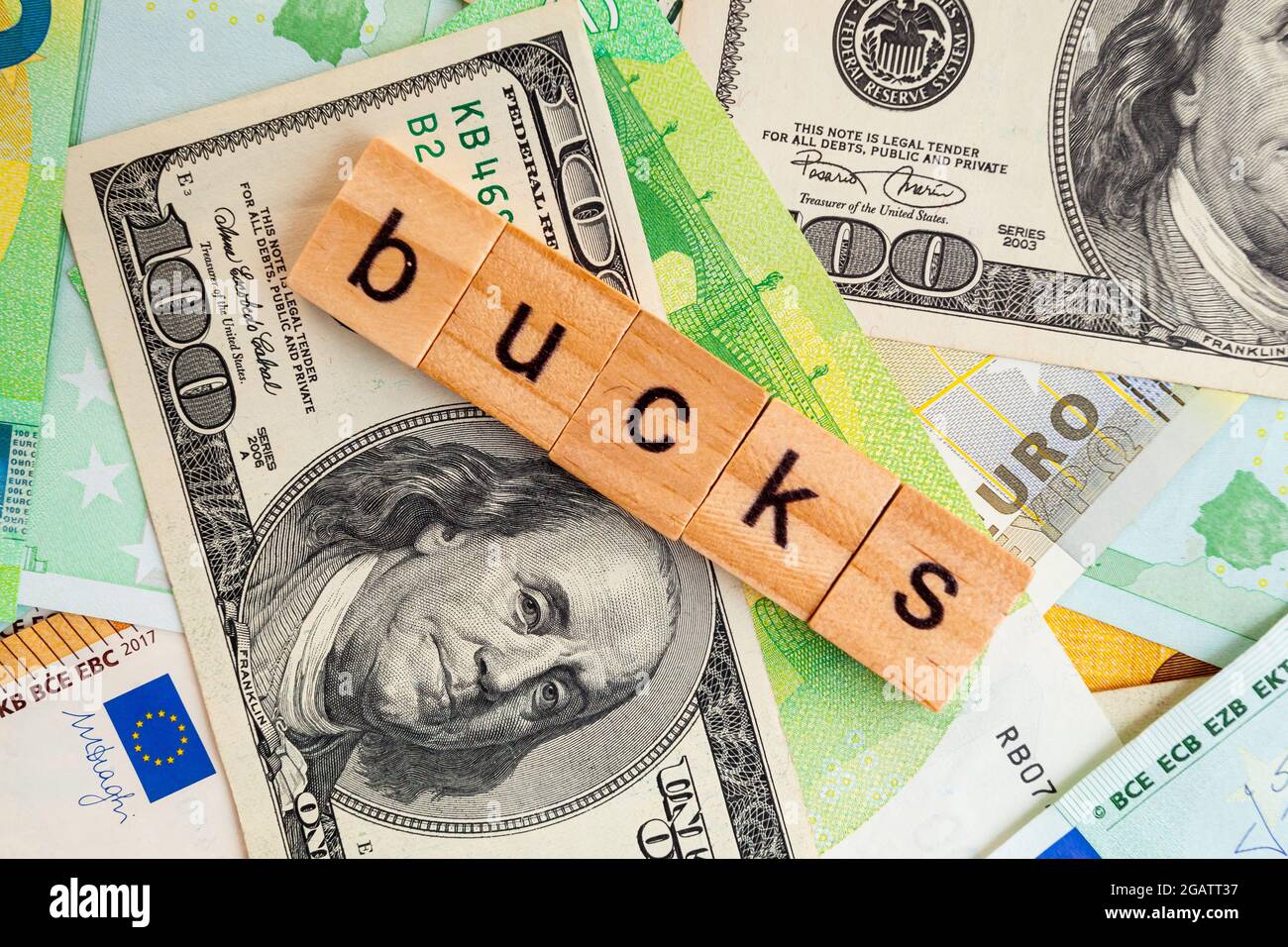 BUCKS inscription on wooden cubes on the texture of us dollars and euro ...