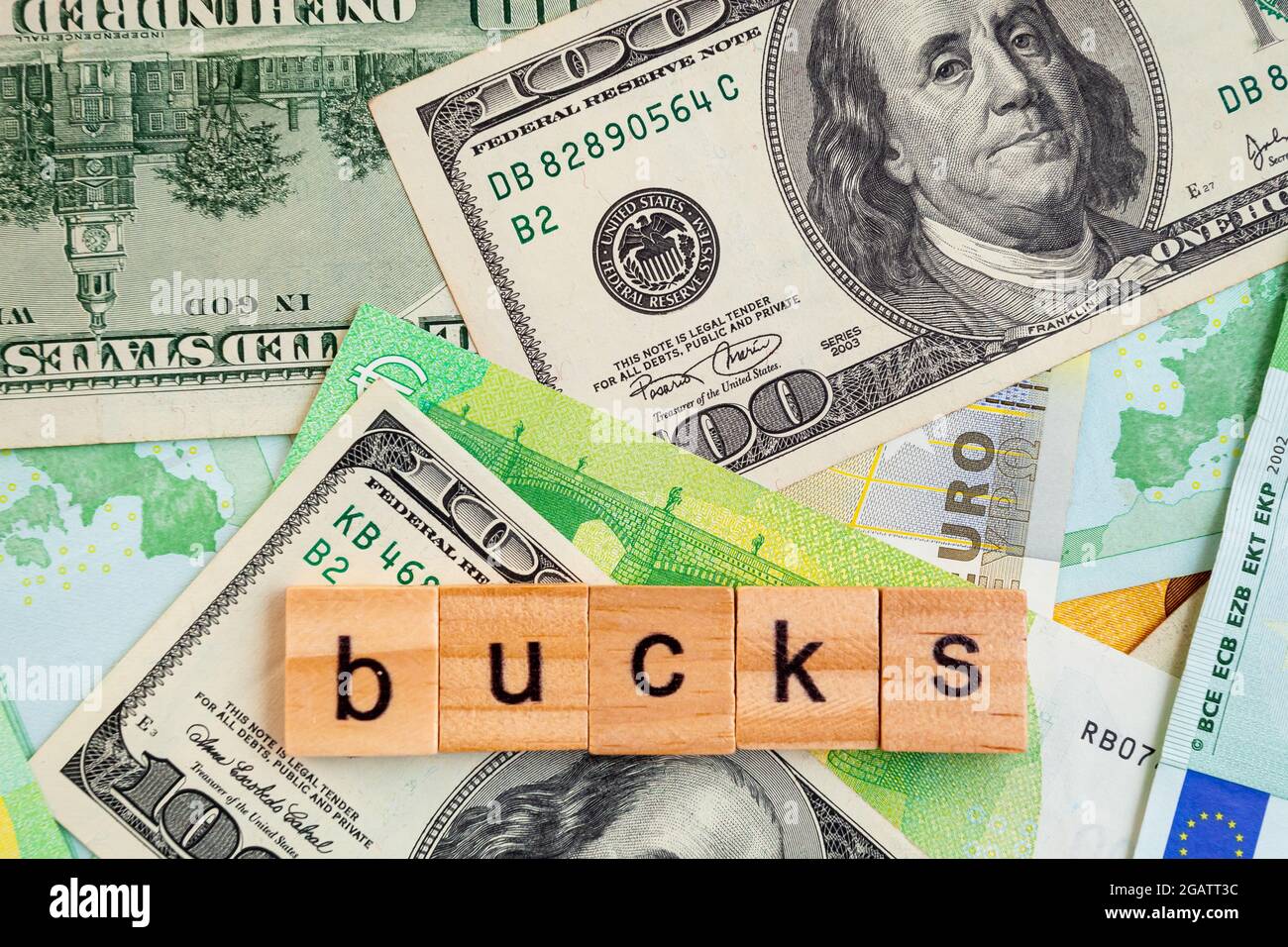 BUCKS inscription on wooden cubes on the texture of us dollars and euro ...