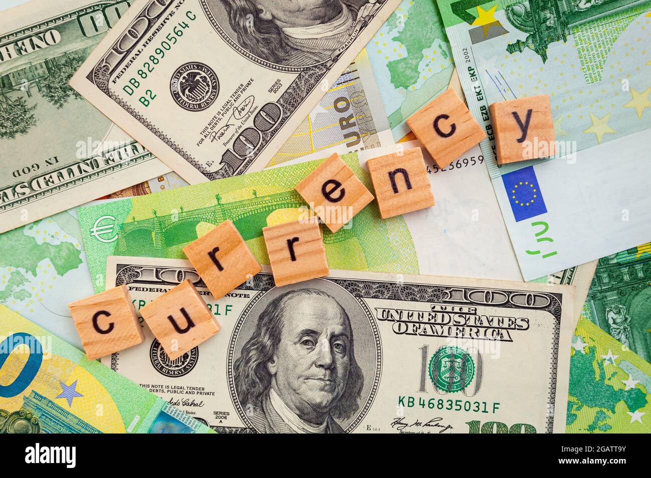 CURRENCY inscription on wooden cubes on the texture of us dollars and ...