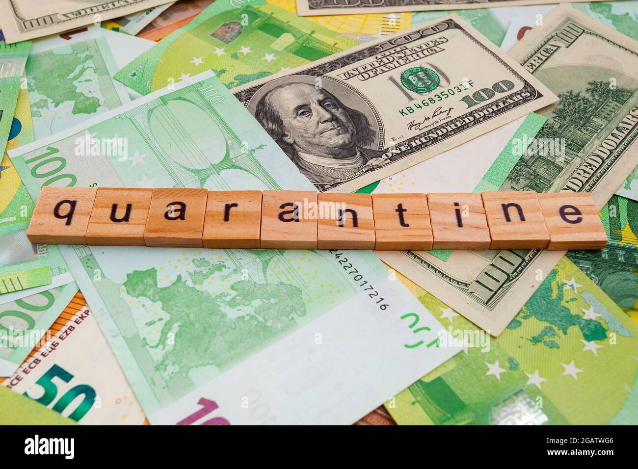 QUARANTINE inscription on wooden cubes on the texture of us dollars and ...