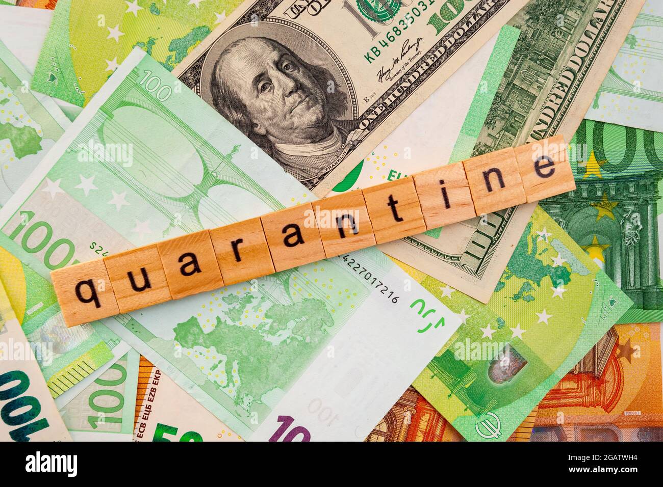 QUARANTINE inscription on wooden cubes on the texture of us dollars and ...