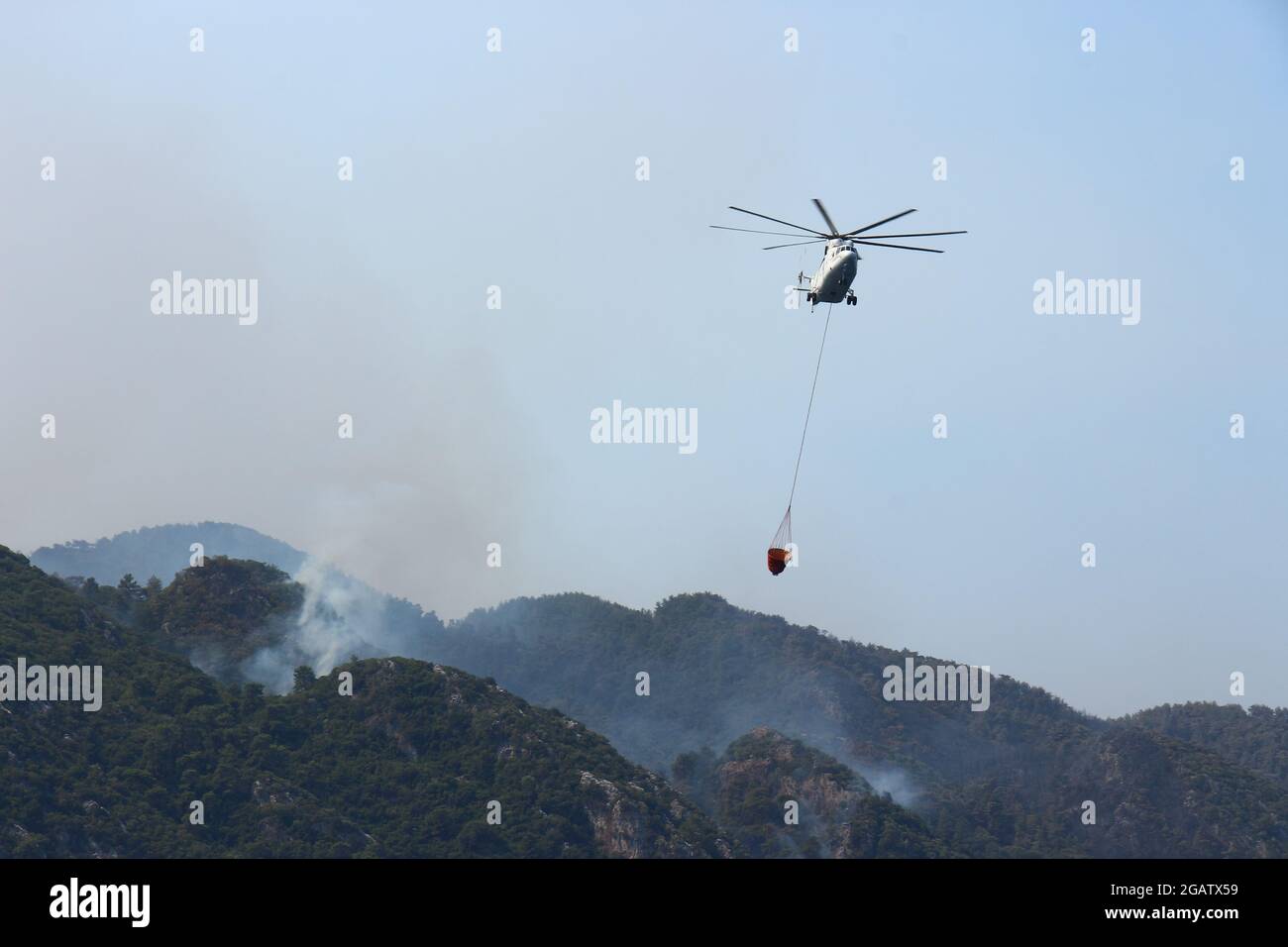 A helicopter responds a forest fire in Marmaris district in Mugla ...