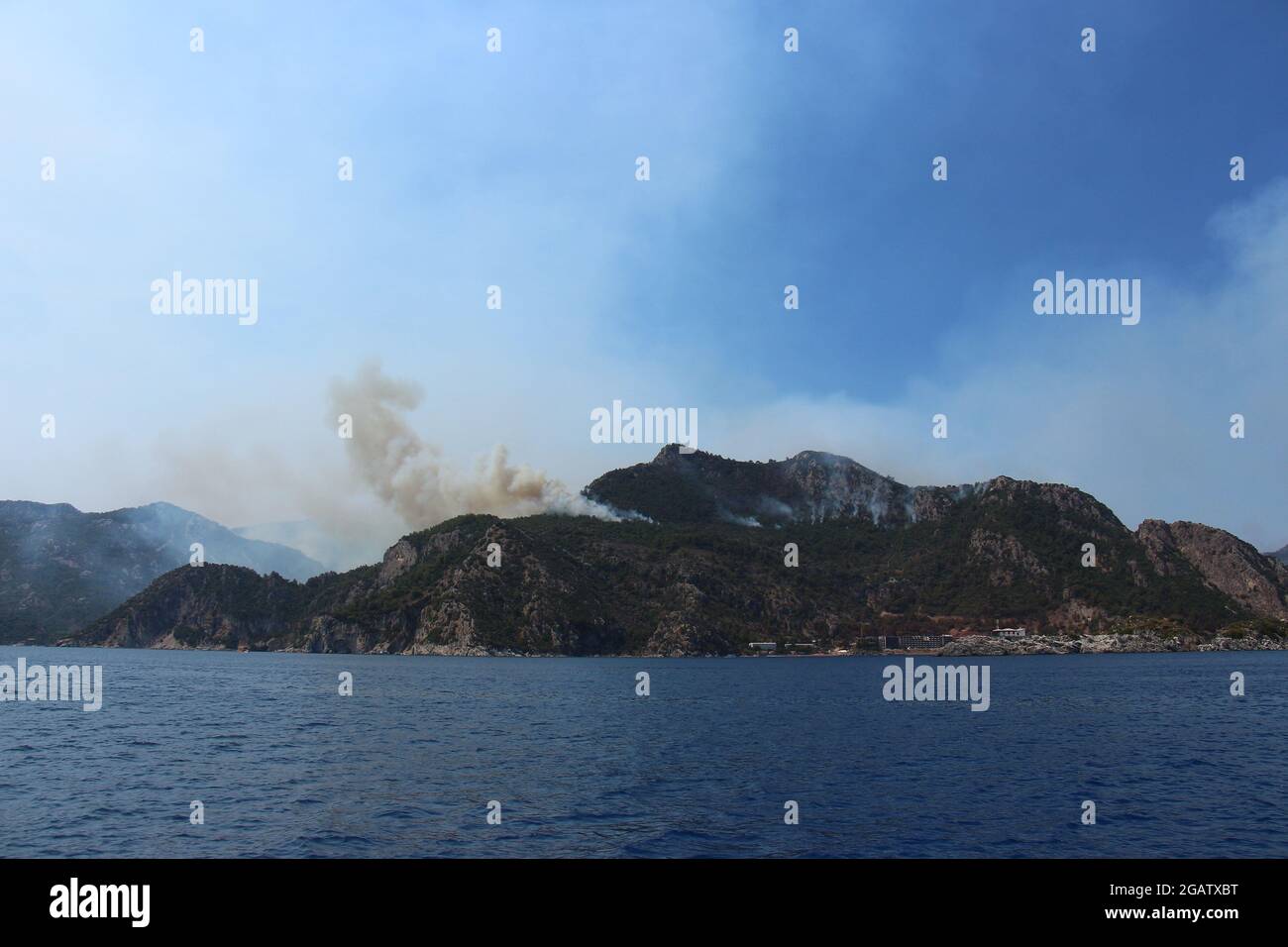 Smoke rises from a forest fire in Marmaris district in Mugla, Turkey ...