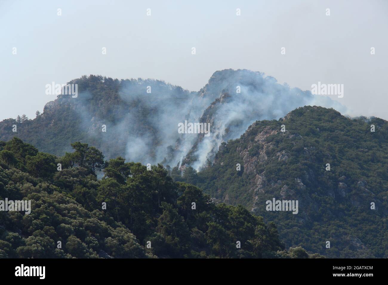 Smoke rises from a forest fire in Marmaris district in Mugla, Turkey ...