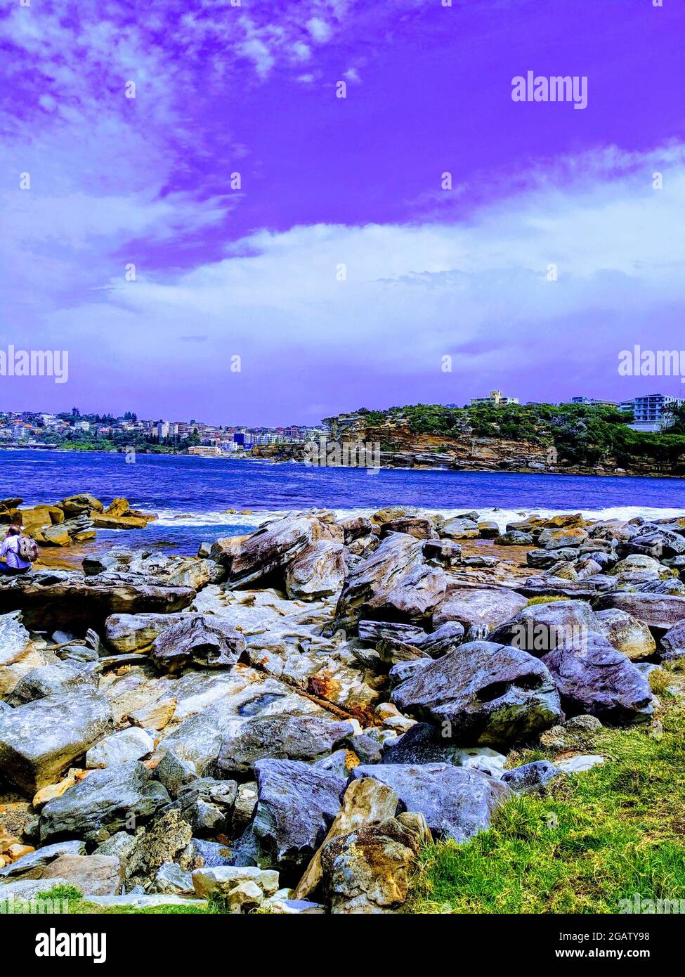 The rocks on the shore of a sea during daytime Stock Photo - Alamy