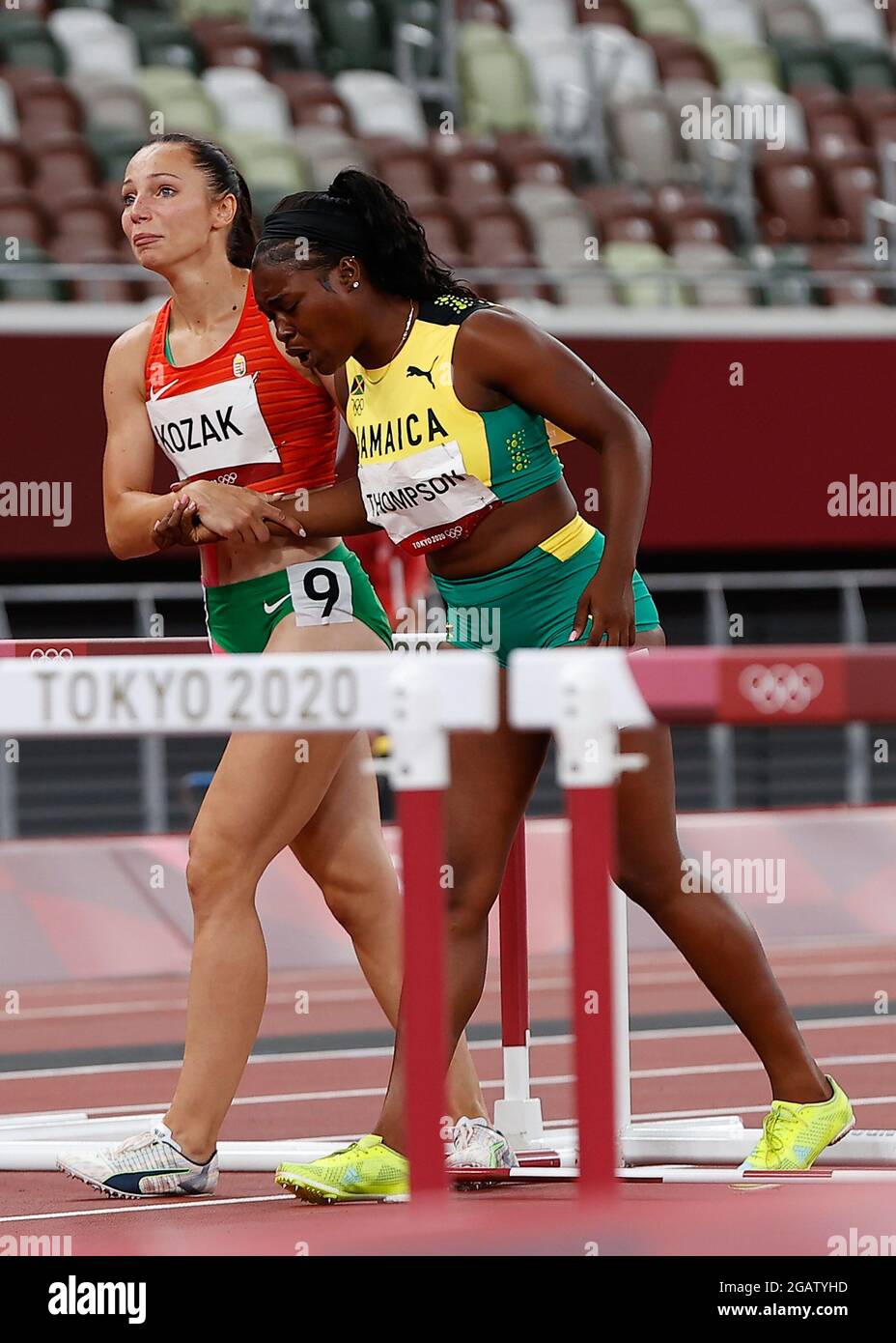 Tokyo, Japan. 1st Aug, 2021. Yanique Thompson (R) of Jamaica falls ...