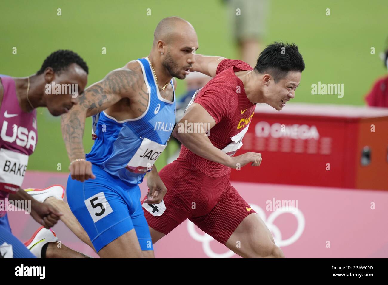 China's Su Bingtian (R) and Italy's Lamont Marcell Jacobs (C) cross the ...