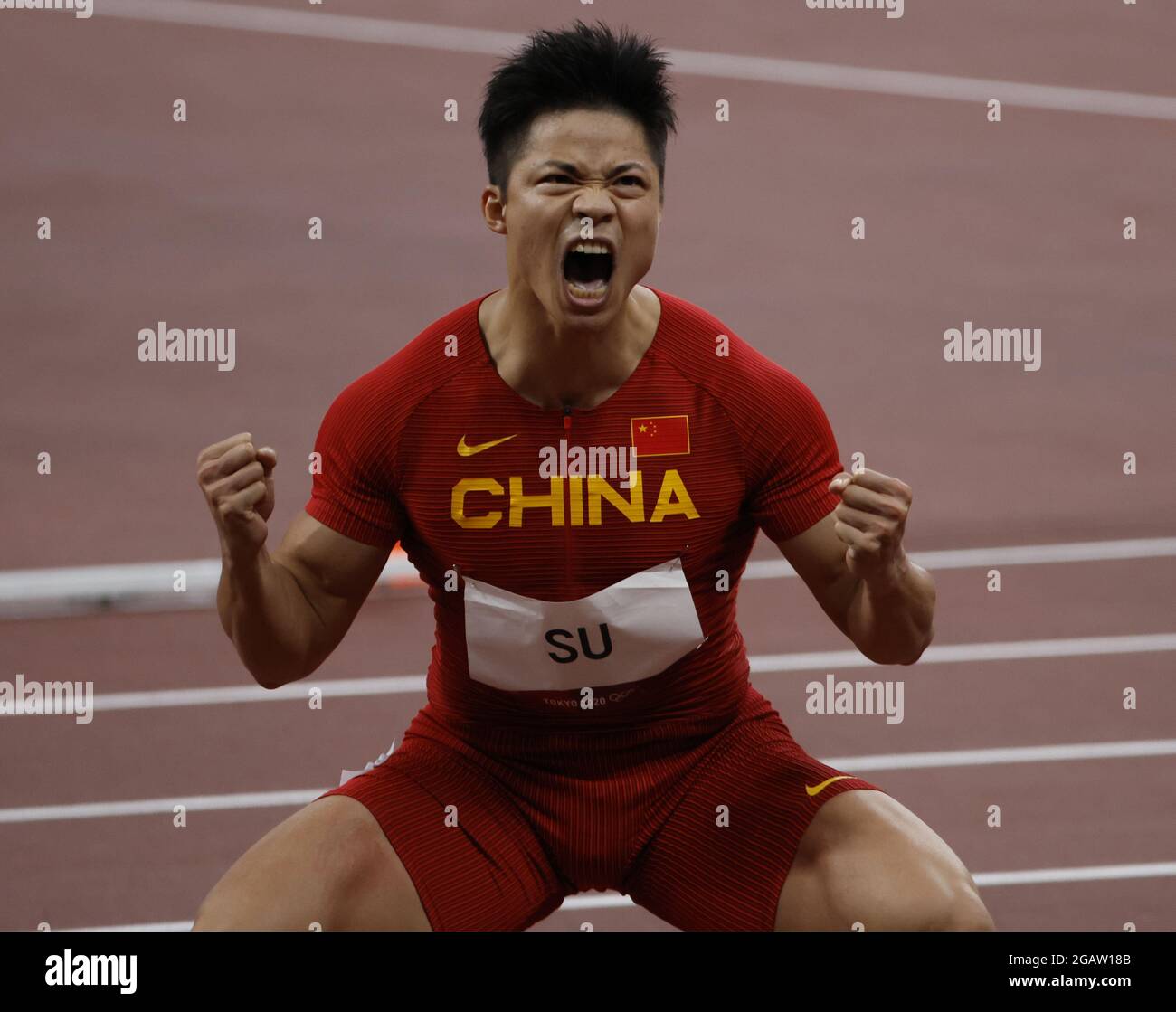 China's Bingtian Su reacts after winning 100m semifinal heat three with a time of 9.83 at ...