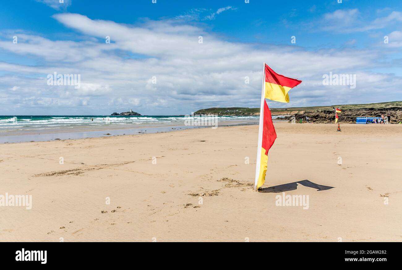 Swimming area marked by lifeguards flags at Godrevy in North Cornwall ...