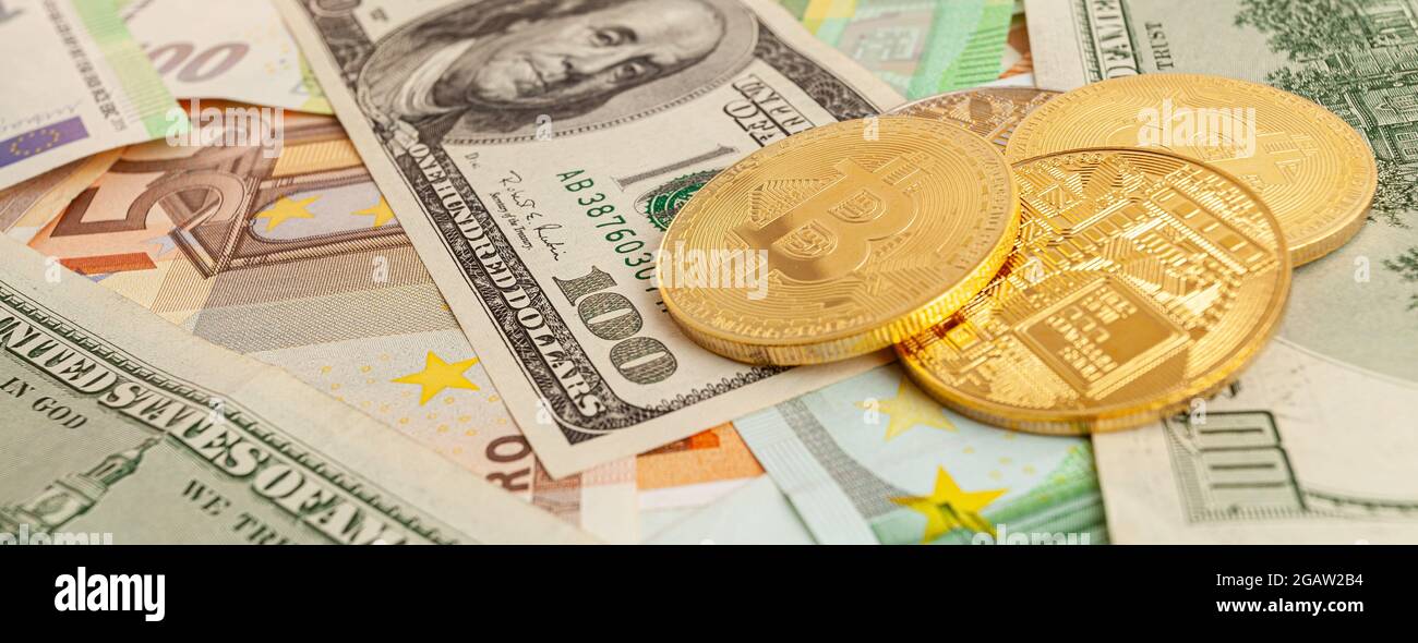 bitcoins on a texture background of euro and dollars panorama Stock ...