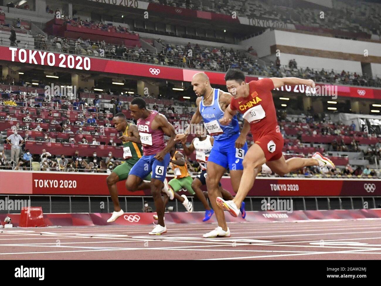 Chinese sprinter Su Bingtian (R) crosses the finish line to win his 100 ...