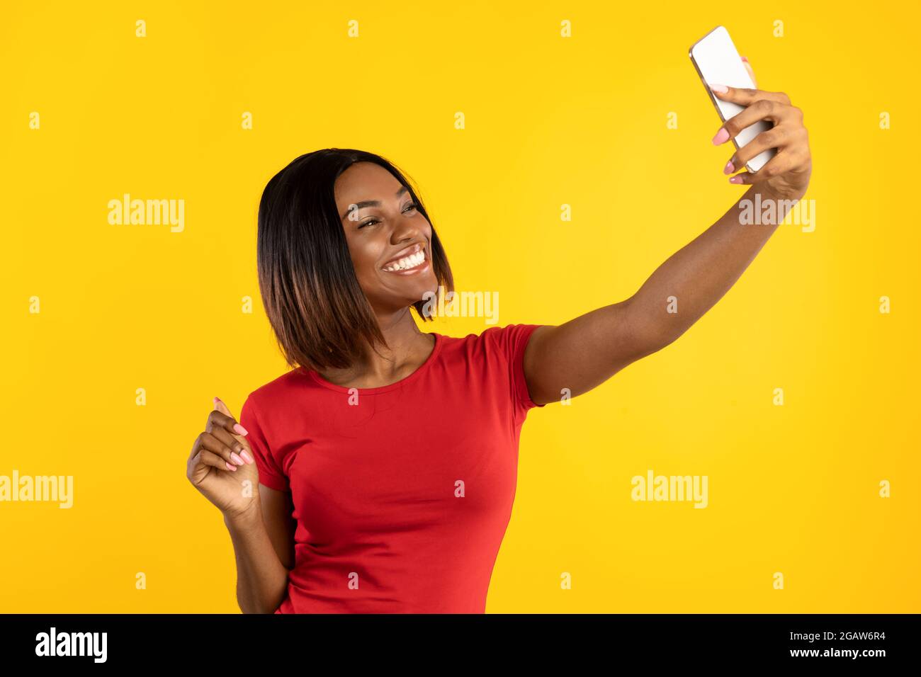 Happy Black Female With Smartphone Making Selfie Portrait Posing And Having Fun Standing On ...